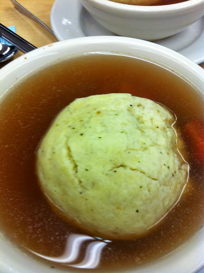 A matzo ball floating like a delicious planet in a universe of golden broth. Gravity-defying yet somehow comforting at the same time.