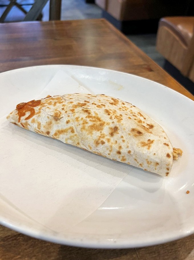 Melted cheese cascades over perfectly seasoned meat in this skillet quesadilla, topped with fresh vegetables that add both color and crucial contrast.