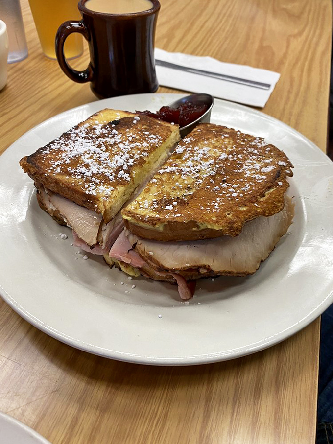 The Monte Cristo sandwich: French toast meets ham and cheese in a powdered sugar snowstorm that would make even dessert jealous.