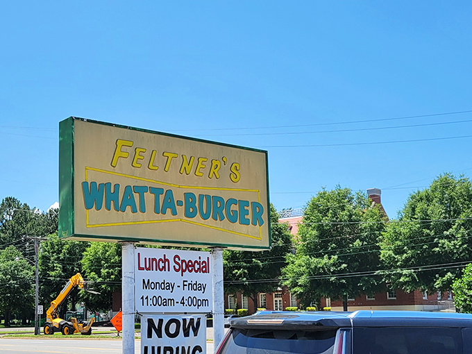 The sign beckons like a yellow lighthouse guiding hungry travelers to safe harbor. A beacon of burger brilliance.