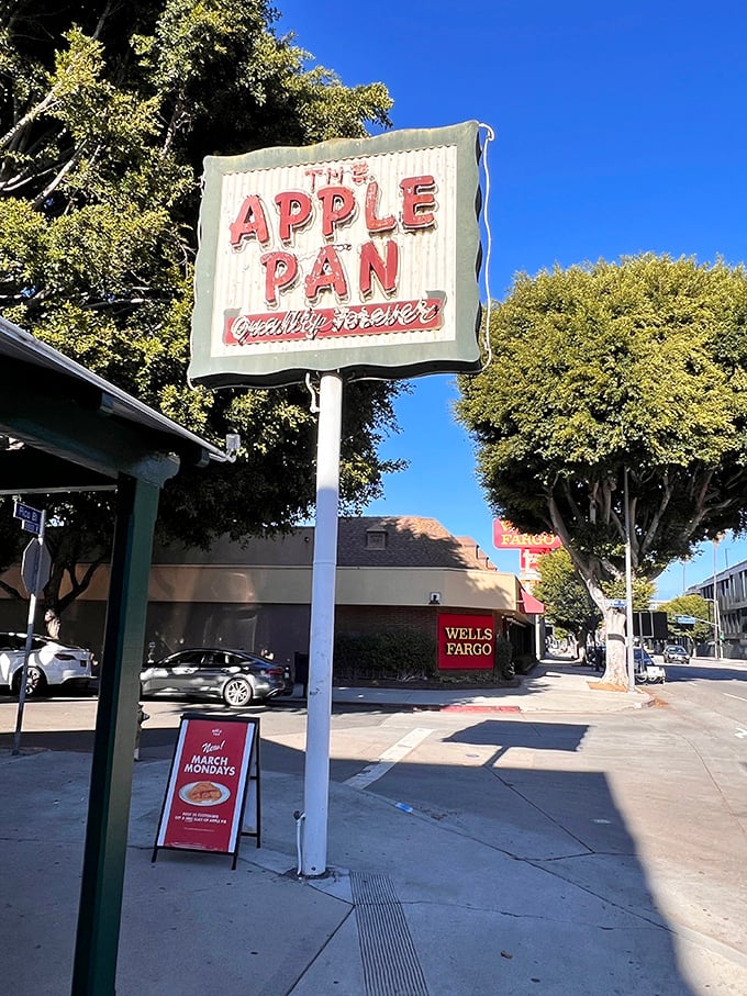 That vintage sign against California's blue sky is more than advertisement; it's a beacon for burger lovers and a landmark of Los Angeles culinary history.