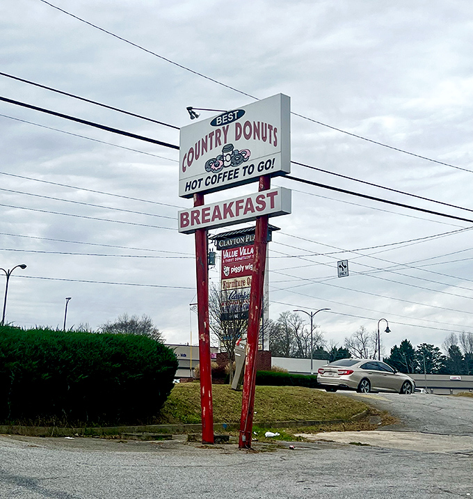 The roadside beacon that guides hungry travelers to donut salvation. This sign has directed countless morning pilgrimages.