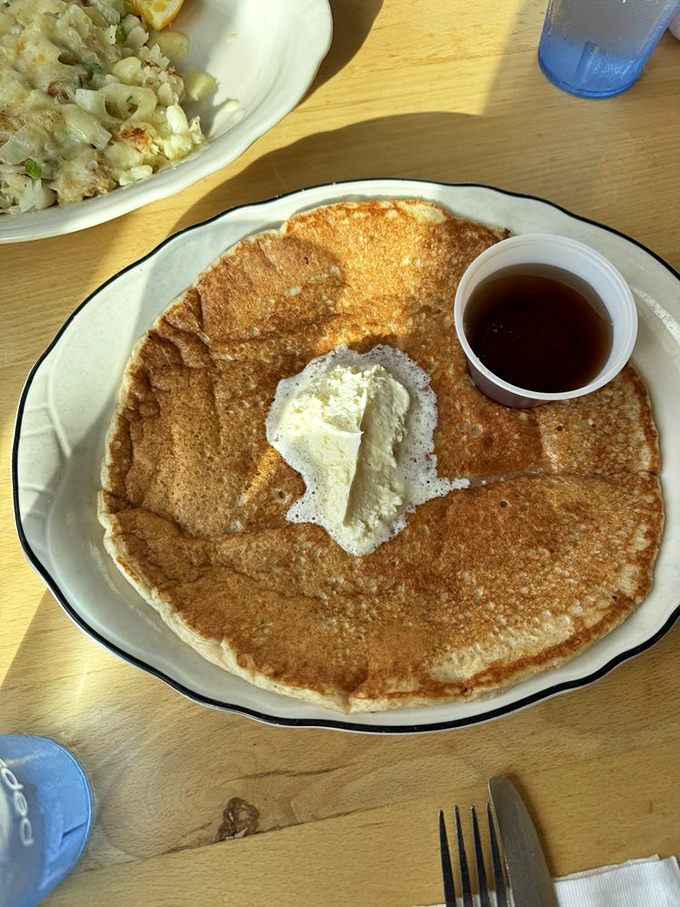 A pancake so perfectly golden it deserves its own Instagram account. That melting butter creates a little pool of happiness waiting to meet the maple syrup.