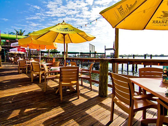 Yellow umbrellas, wooden deck chairs, and water views that make you forget deadlines exist. This patio is therapy without the copay.