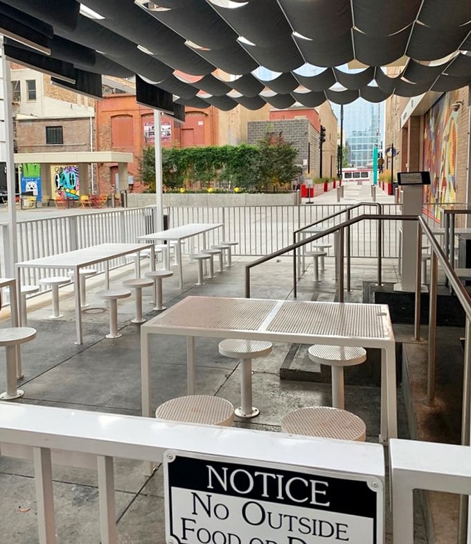 The outdoor patio offers urban al fresco dining with industrial charm. Though the sign warns against outside food, nobody's bringing anything in&mdash;they know better.