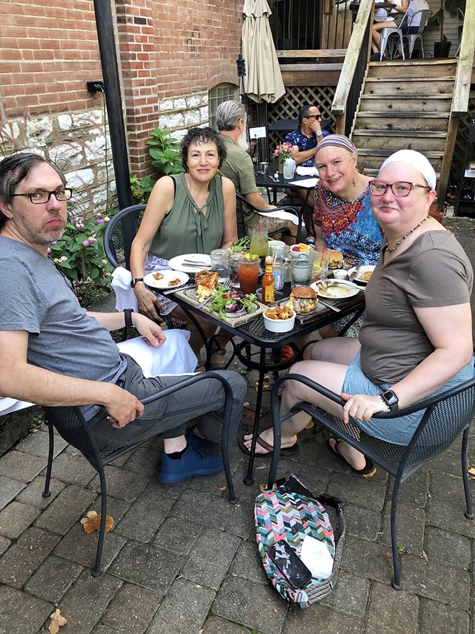 Outdoor dining at its finest, where friends gather around iron tables to share good food and even better conversation.