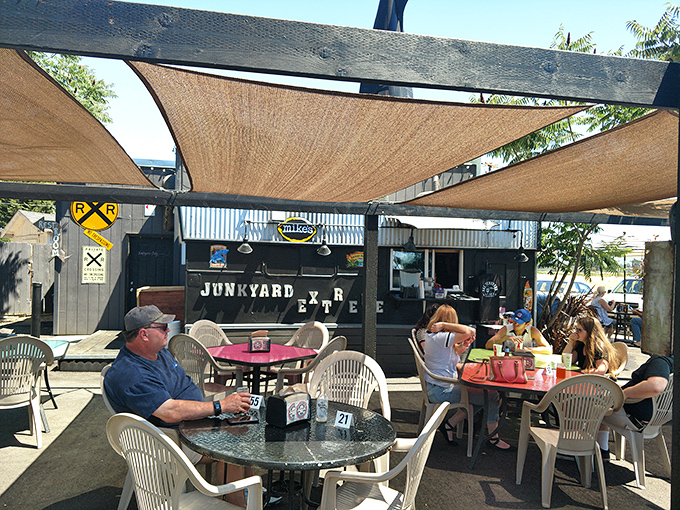The outdoor seating area: where Oregon summer days meet exceptional burgers under shade sails and open skies. 