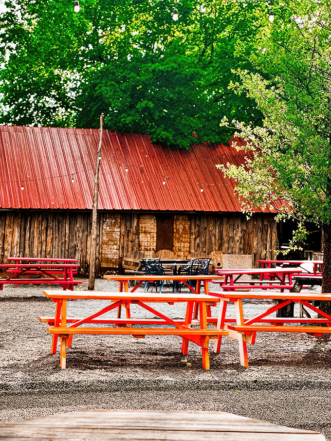 Red picnic tables outside invite diners to enjoy their chicken feast al fresco, surrounded by Oklahoma's natural beauty.