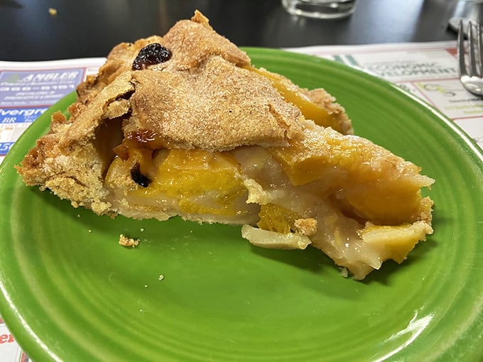 A slice of heaven on a bright yellow plate. The contrast between flaky crust and juicy filling is the stuff of midwestern dreams.