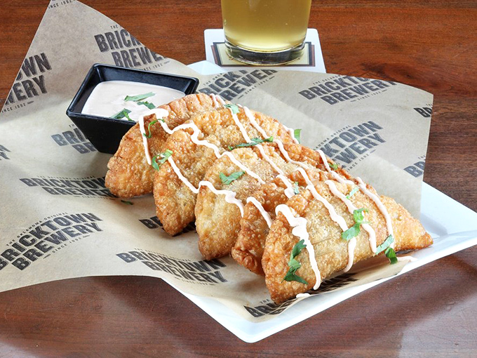 These empanadas aren't just appetizers&mdash;they're little pockets of happiness. The drizzle of sauce adds both beauty and an extra layer of flavor.