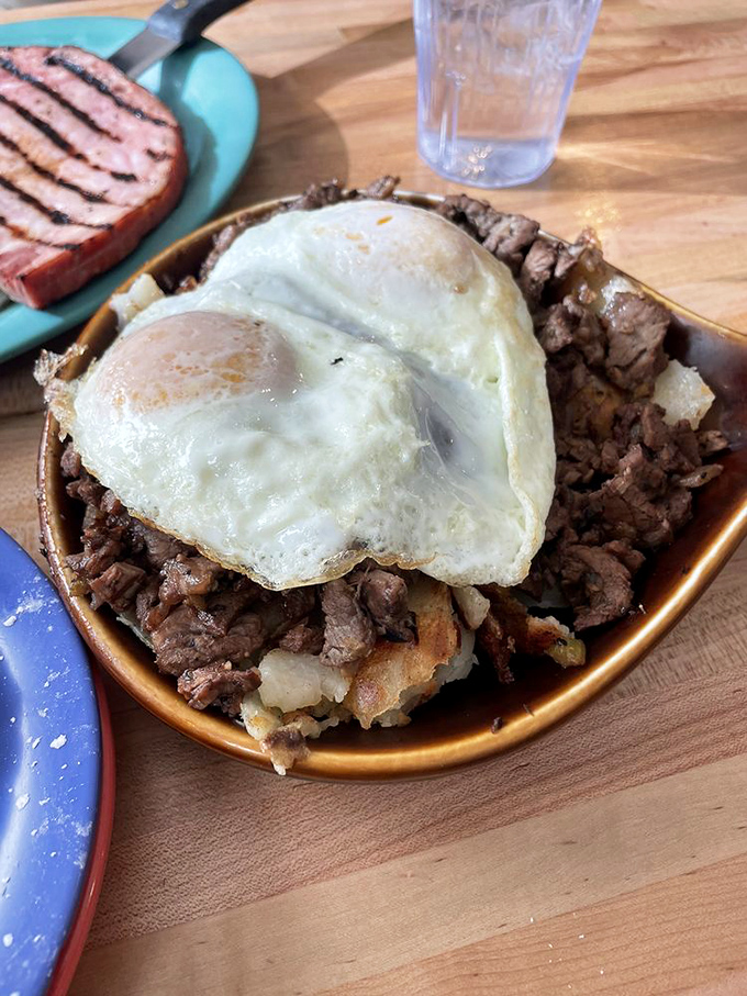 Prime rib hash topped with sunny-side-up eggs&mdash;proof that leftovers can have a glorious second act worthy of a standing ovation.