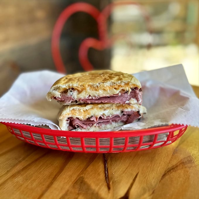 The Reuben: where sauerkraut and corned beef meet in a melty, messy dance that's worth every napkin you'll need afterward.