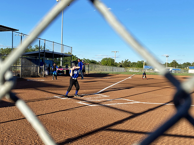 Through the chain-link fence, Russell's softball fields promise the quintessential American summer evening&mdash;complete with hot dogs and friendly heckling.