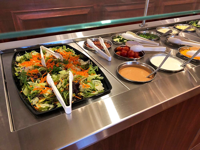 The salad bar stands ready for those who want to pretend they're eating healthy before diving into fried chicken paradise.