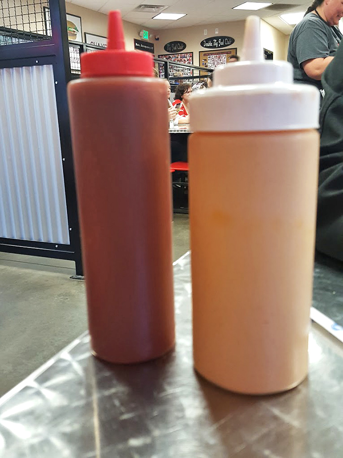 These sauce bottles stand like sentinels of flavor, ready to enhance your burger experience with tangy, creamy reinforcements.