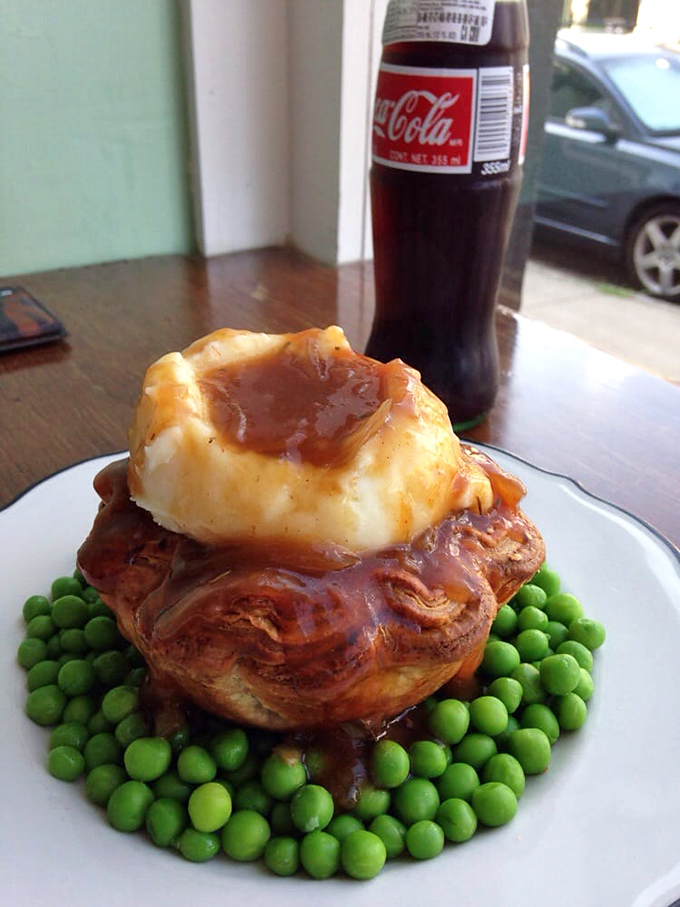 A savory pie throne atop a kingdom of peas. This architectural marvel of pastry, mashed potatoes and gravy demands both a fork and respect.
