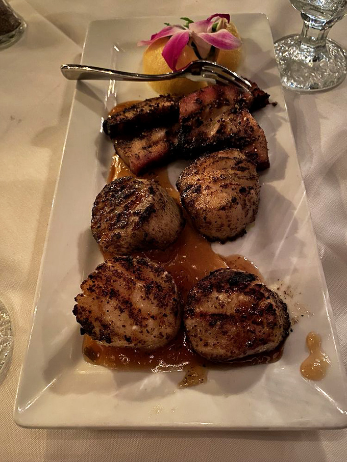 These scallops have dressed for dinner, seared golden and swimming in buttery sauce with just enough acidity to make your taste buds dance.