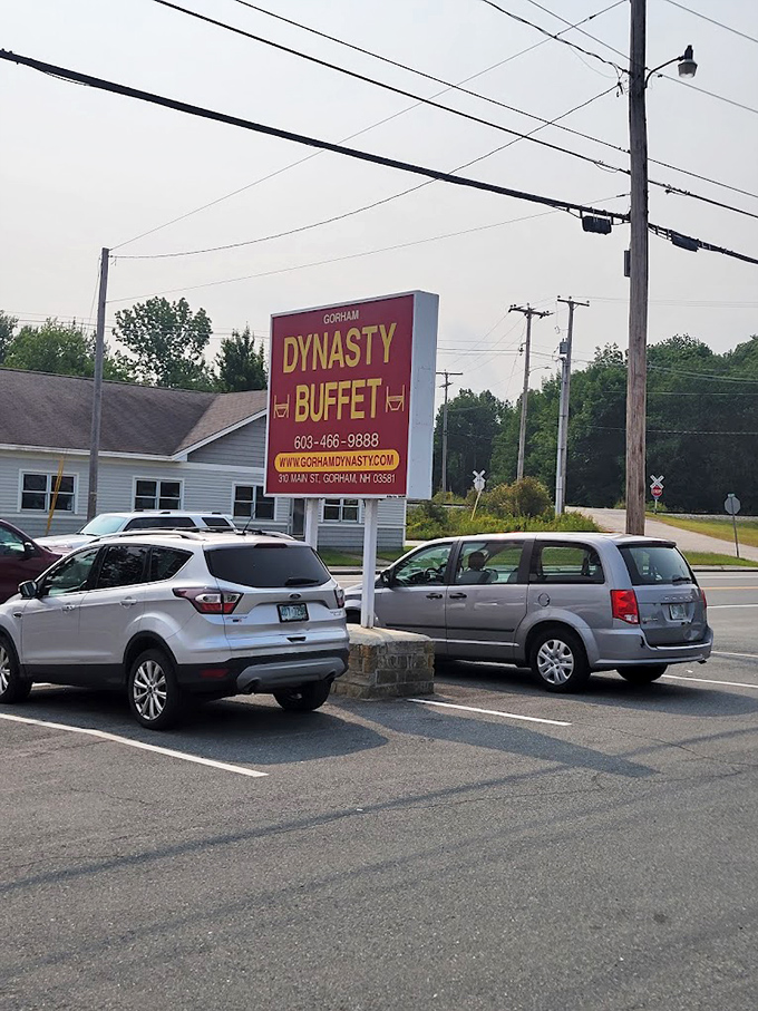 The roadside marquee stands tall against the New Hampshire sky, a crimson promise of abundance that's hard to miss or resist.