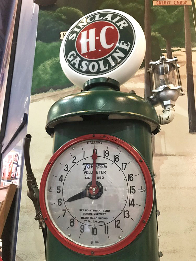 The Sinclair pump's vintage dial face recalls simpler times when gas was cheap and American highways promised adventure. Museum magic makes yesterday's ordinary today's extraordinary.