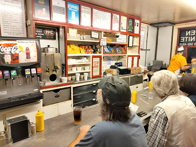 Behind the counter, where the magic happens&mdash;yellow mustard bottles standing at attention like soldiers guarding flavor territory.
