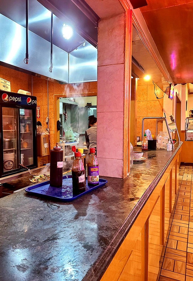 Behind the scenes, where sauces simmer and woks sizzle, the kitchen keeps the buffet trays filled with fresh offerings.