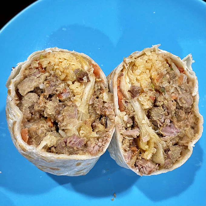 Cut in half to reveal its secrets, this steak burrito showcases the perfect rice-to-meat ratio that separates the burrito masters from the amateurs.