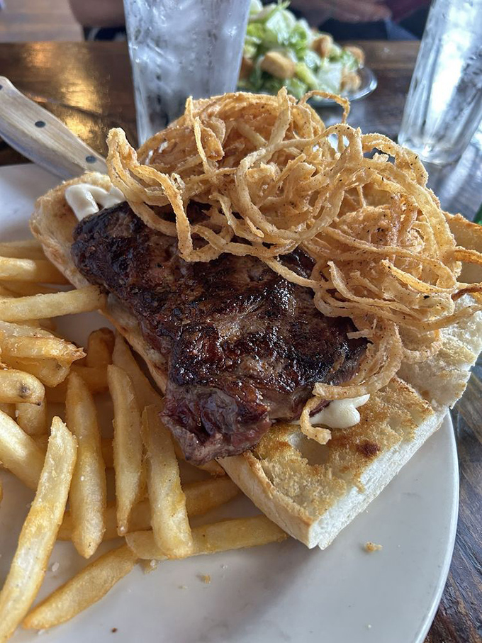 A steak sandwich that doesn't whisper but announces its presence with crispy onion strings that could win a talent competition for best supporting crunch.