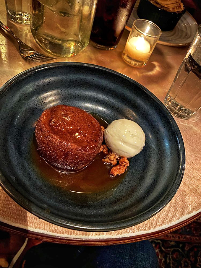 Sticky toffee pudding that glistens with intention, surrounded by a moat of caramel sauce and accompanied by ice cream melting at just the right pace&mdash;dessert architecture at its finest.