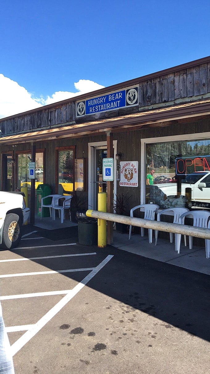 Plastic chairs outside create an impromptu waiting area where anticipation builds. That "OPEN" sign might be the happiest word in the English language.
