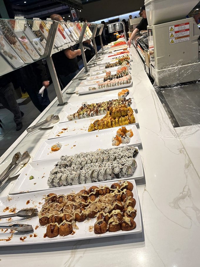 The sushi bar stretches impressively, offering endless opportunities for "just one more piece" until your plate looks like an art installation.