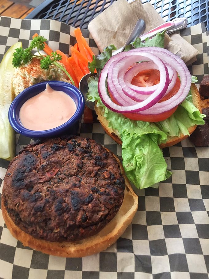 A veggie burger that doesn't apologize for not being meat &ndash; it stands proudly on its own merits with toppings arranged like a colorful crown.