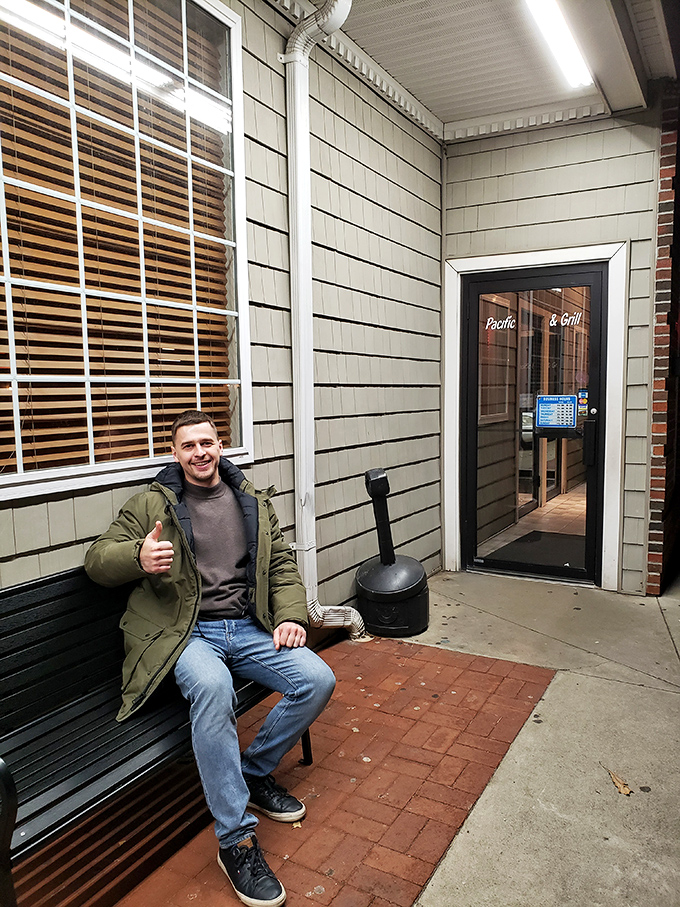 The universal sign of buffet satisfaction &ndash; a happy customer giving the thumbs-up after conquering multiple plates without regret.