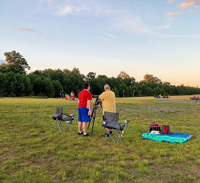Amateur astronomers setting up before sunset—like cosmic chefs preparing a feast of planets, stars, and galaxies that will soon be served on the darkest of platters.