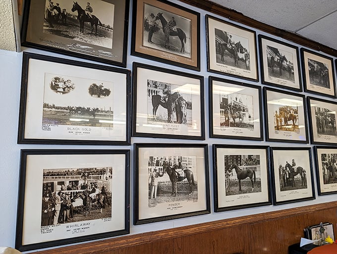 A wall of racing royalty where every photo tells a story of thundering hooves, photo finishes, and Kentucky history written in dirt and glory.