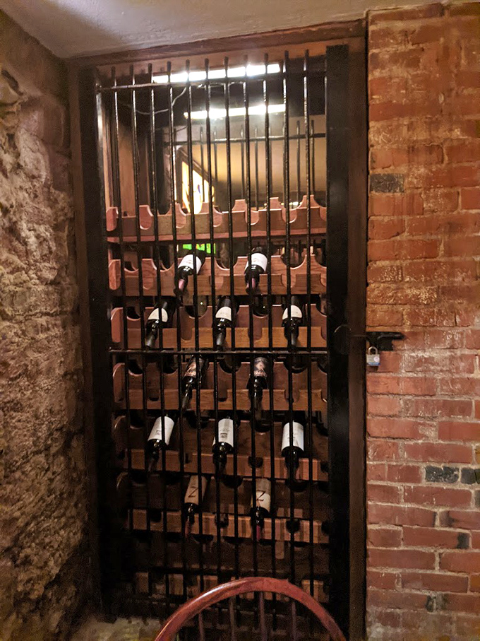 Wine bottles resting behind bars &ndash; perhaps the only "inmates" happy to be locked up in this former jailhouse.