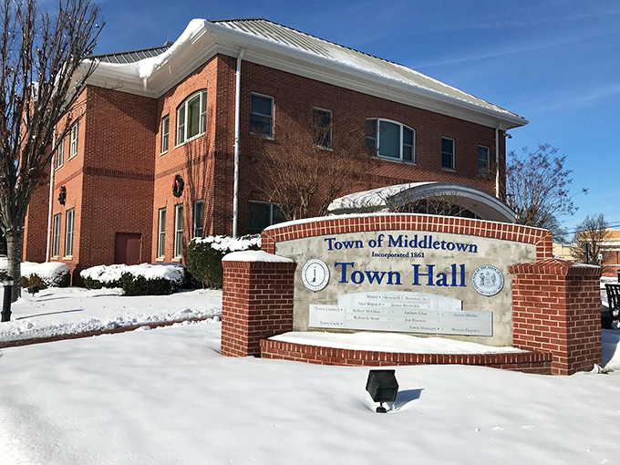 Town Hall wears its winter coat of snow with dignity. The brick and white combination looks like something from a holiday card you'd actually keep.