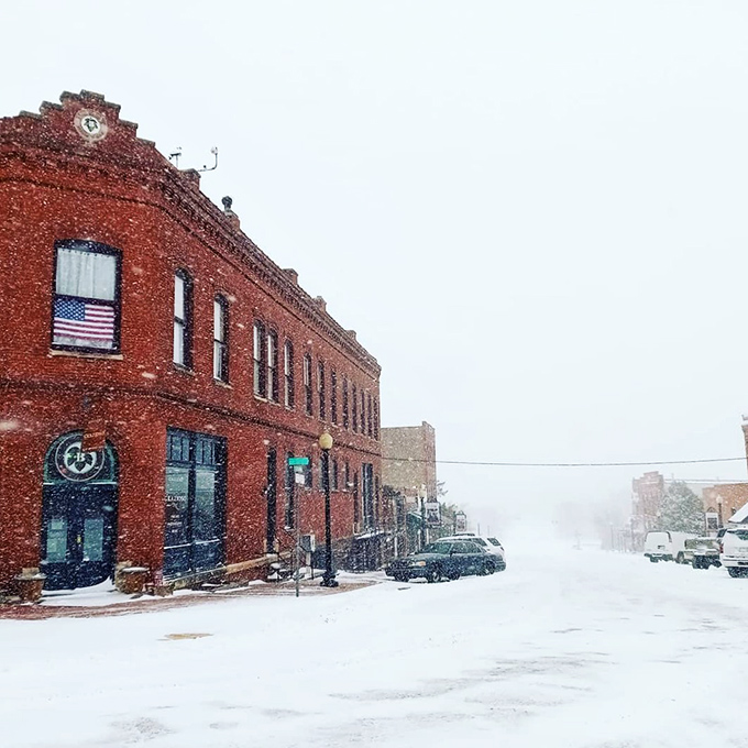 Winter transforms Guthrie's brick streets into a snow globe scene. The red buildings pop against white snow like a vintage Christmas card come to life.
