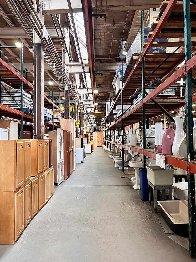 An aisle of architectural salvation where cabinet doors, bathroom fixtures, and possibilities stretch as far as the eye can see.