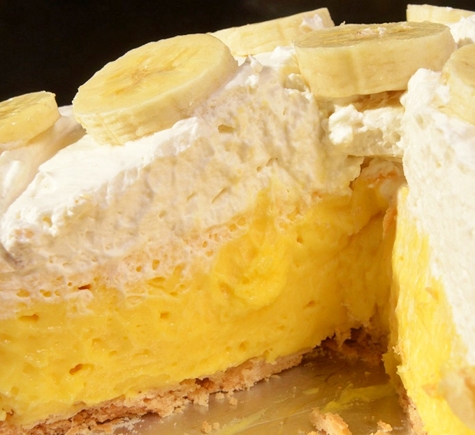Banana cream pie with a sunshine-yellow custard that would make a tropical island jealous. Topped with fresh bananas and pillowy whipped cream.