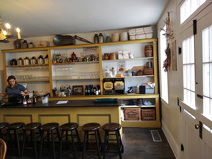 The tavern's bar area maintains its historical charm with original shelving and wood-worn stools that have supported countless storytellers.