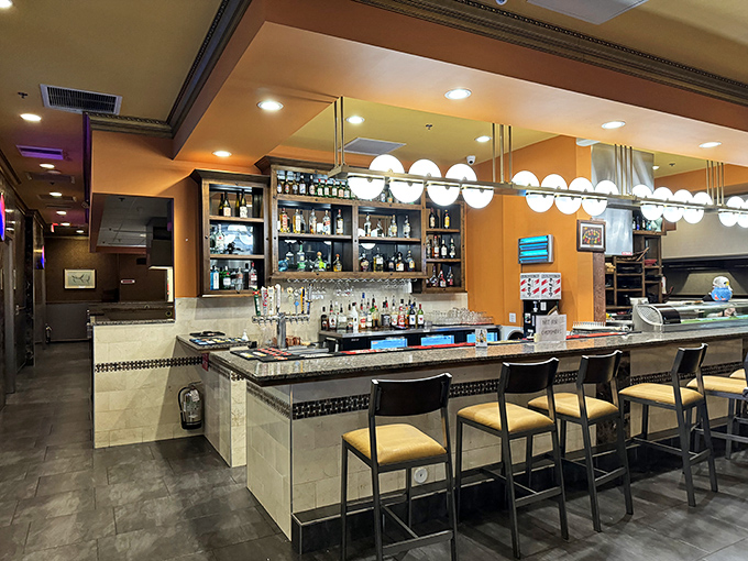 The bar gleams with promise, bottles standing at attention like delicious soldiers waiting to complement your feast with liquid courage.