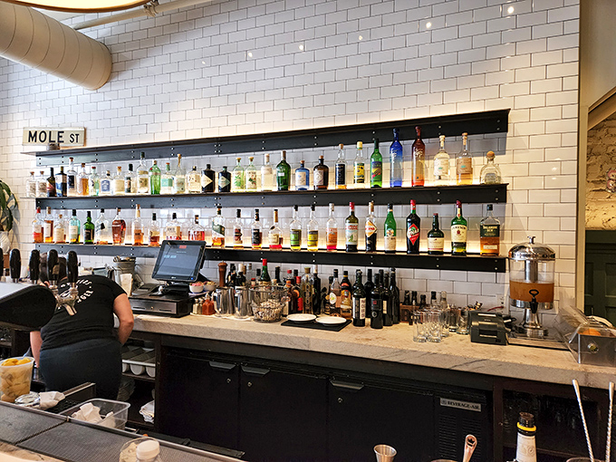 The bar area gleams with promise and premium spirits. Those white subway tiles have witnessed more food joy than a cooking channel marathon.