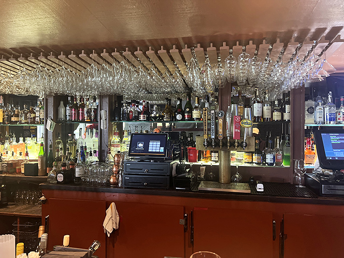 The bar area &ndash; where strangers become friends and friends become regulars. Those hanging glasses catch the light like crystal chandeliers.