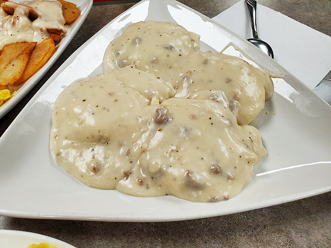 This boat of biscuits and gravy could float you straight to comfort food heaven. The speckled gravy reveals secrets only grandmothers know.