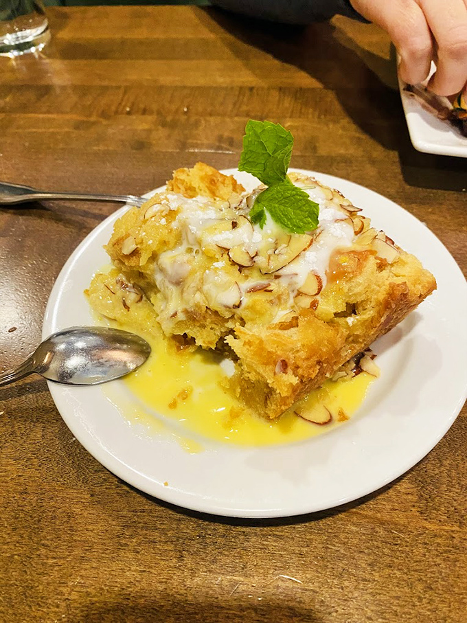 Bread pudding that glistens with buttery sauce. That mint leaf isn't decoration &ndash; it's there to make you feel better about ordering seconds.