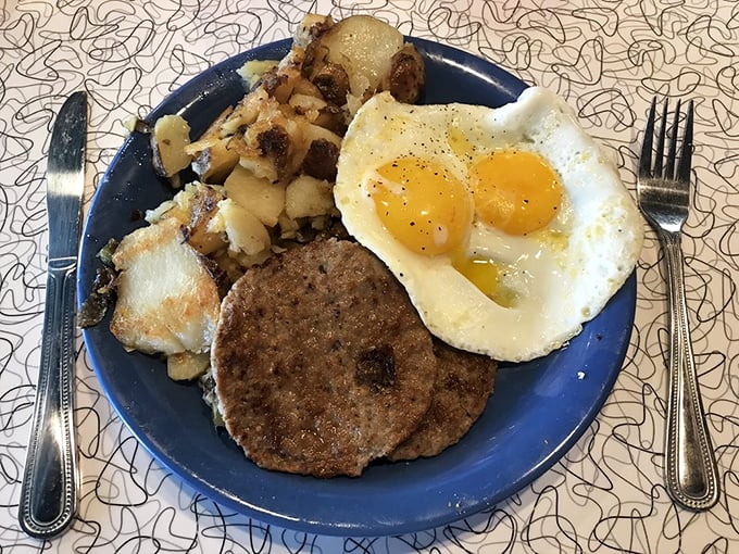 A blue plate special that's actually special: two sunny eggs, seasoned home fries, and a sausage patty that makes you wonder why you ever skipped breakfast.