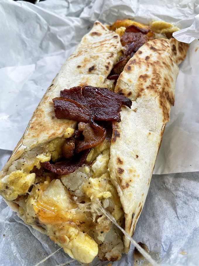 Breakfast burrito autopsy reveals the perfect crime: eggs, potatoes, bacon, and cheese conspiring to ruin all other breakfasts forever.