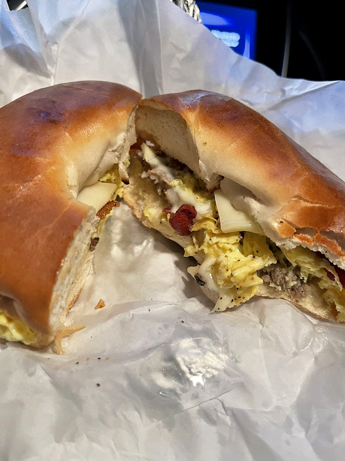 That golden-brown bagel cradles its precious cargo of eggs and cheese like it knows it's carrying edible treasure.