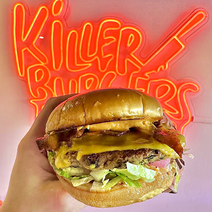This isn't just a burger&mdash;it's a towering achievement of beef, bacon, and cheese posing proudly before its "Killer Burgers" backdrop.
