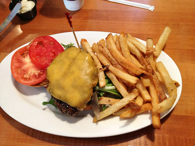 Behold: the burger that launched a thousand road trips. Melted cheese, garden-fresh tomato, and fries that deserve their own fan club.